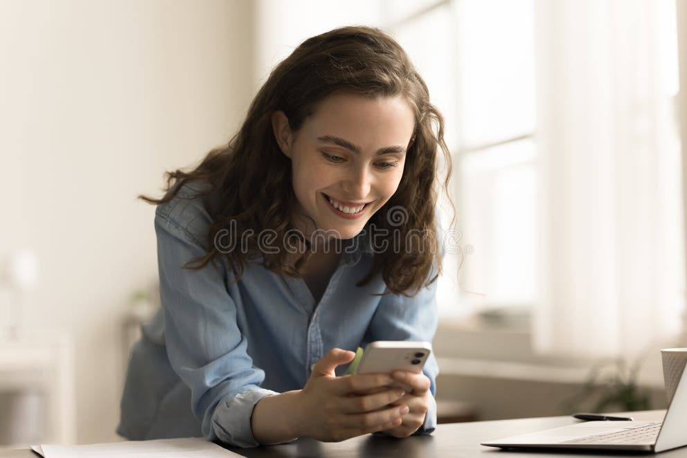 Positive Young Freelancer Girl Using Internet Application on Smartphone ...