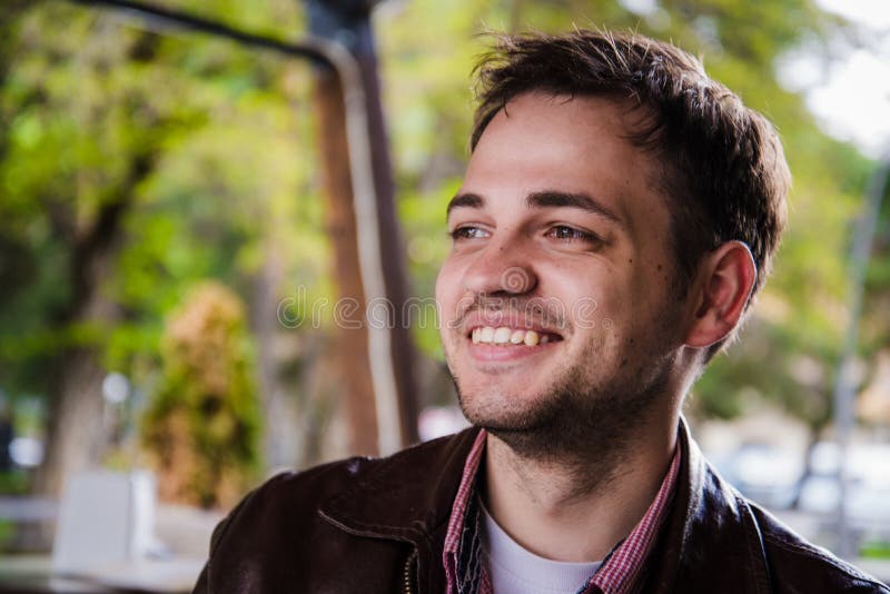 Positive Young Man Alone Behind Table in Summer Cafe Smiling Looking ...
