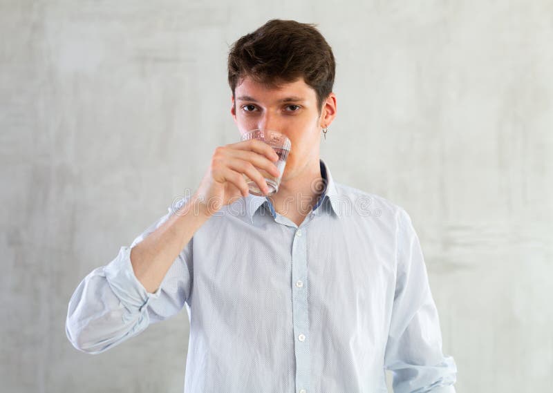Positive Young Man Drinking Water from Glass Stock Image - Image of ...