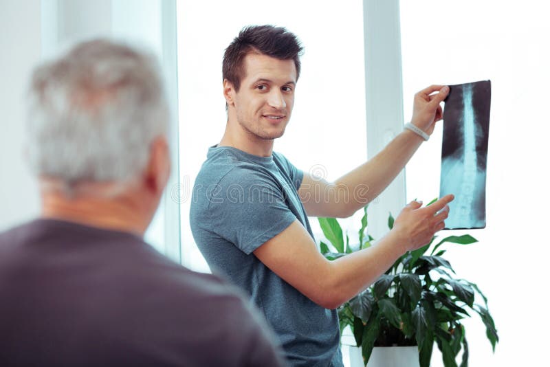 Positive Young Man Showing an X Ray Image Stock Image - Image of light ...