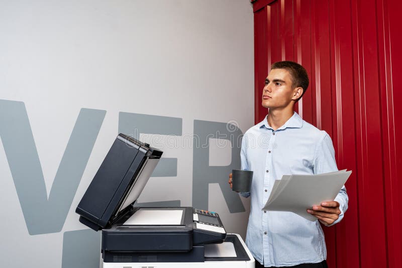 Positive Young Man Using Printer in the Modern Office Stock Image ...