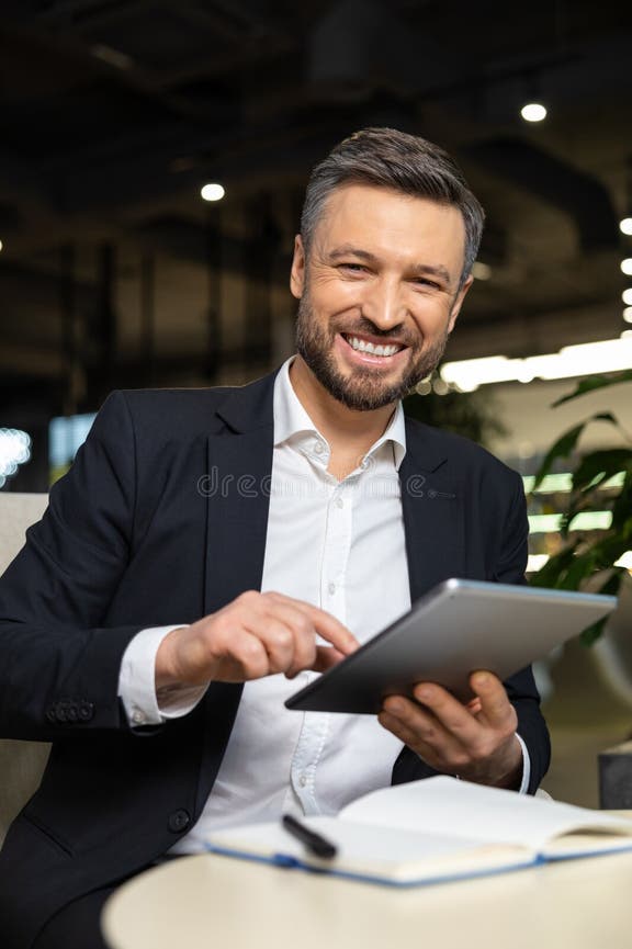 Positive Young Manager with Tablet in Hands Working in the Office Stock ...