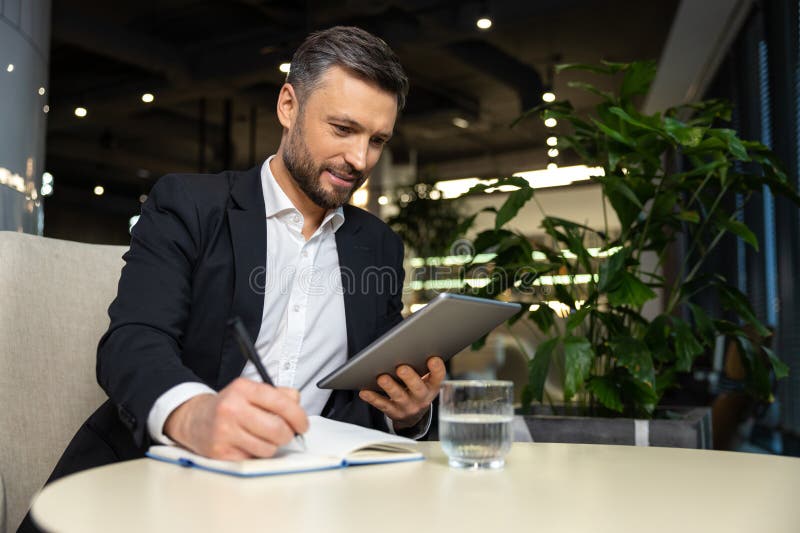 Positive Young Manager with Tablet in Hands Working in the Office Stock ...