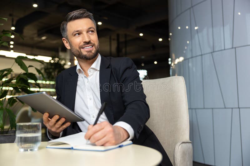 Positive Young Manager with Tablet in Hands Working in the Office Stock ...