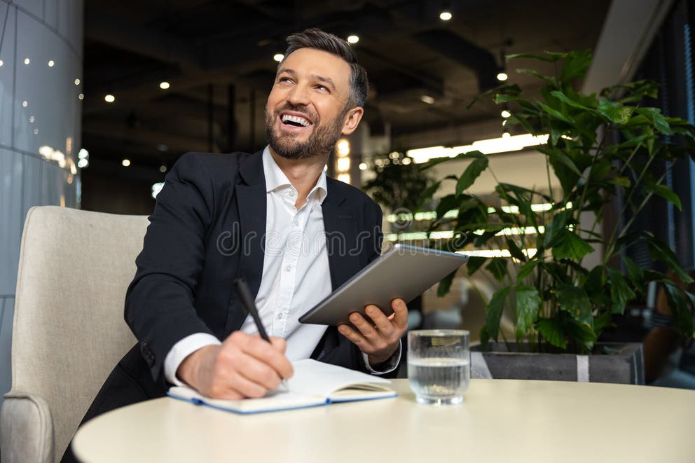 Positive Young Manager with Tablet in Hands Working in the Office Stock ...