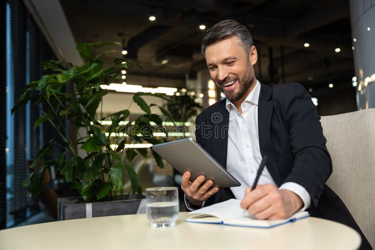 Positive Young Manager with Tablet in Hands Working in the Office Stock ...
