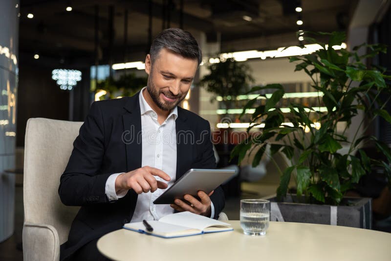 Positive Young Manager with Tablet in Hands Working in the Office Stock ...