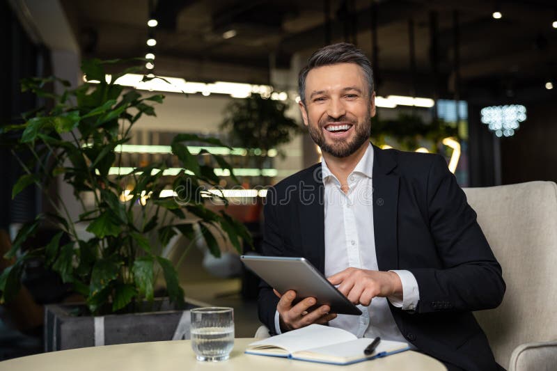 Positive Young Manager with Tablet in Hands Working in the Office Stock ...