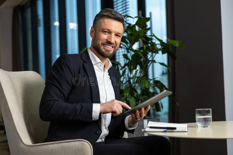 Positive Young Manager with Tablet in Hands Working in the Office Stock ...