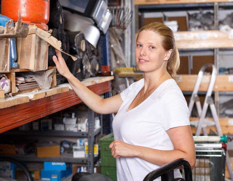 Positive Young Woman Looking Tools with Note List in Build Store Stock ...