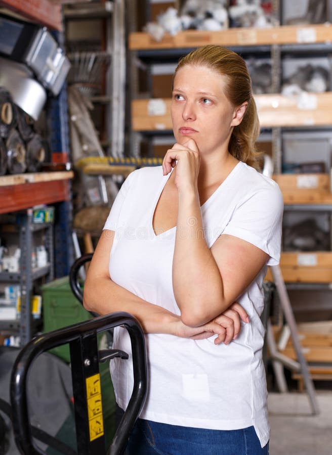 Positive Young Woman Looking Tools with Note List in Build Store Stock ...