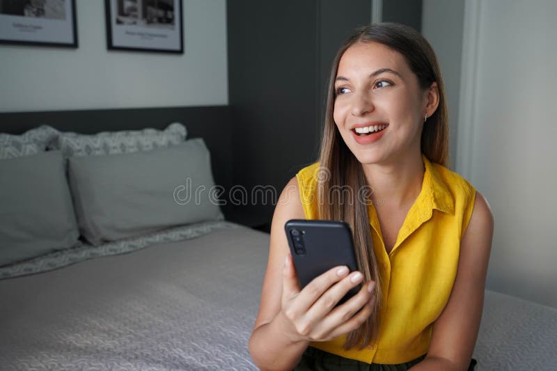 Positive Young Woman Using Smartphone at Home. Internet Connection ...