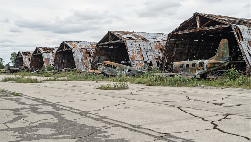 Post Apocalyptic Landscape with Decaying Hangars and Rusted Planes on ...