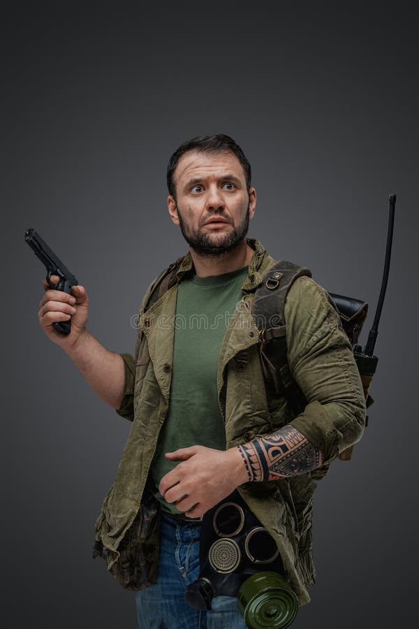 Post Apocalyptic Scared Man with Gun Against Gray Background Stock ...