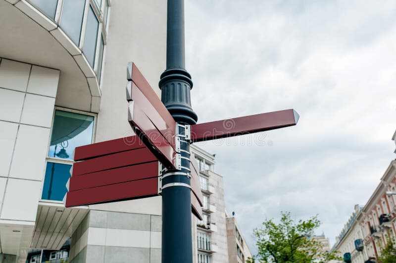 Post with Blank Direction Signs on City Street, Low Angle View Stock ...