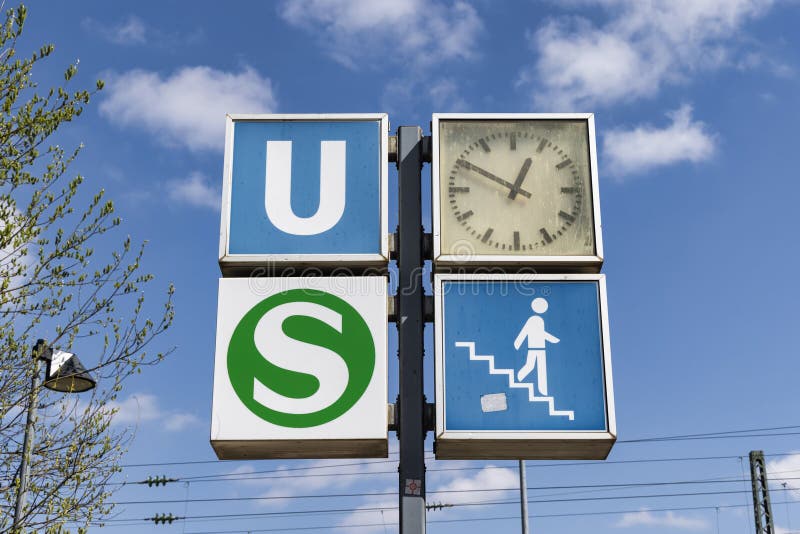 Post with a Clock and Signs for S-bahn and U-bahn in a German City ...