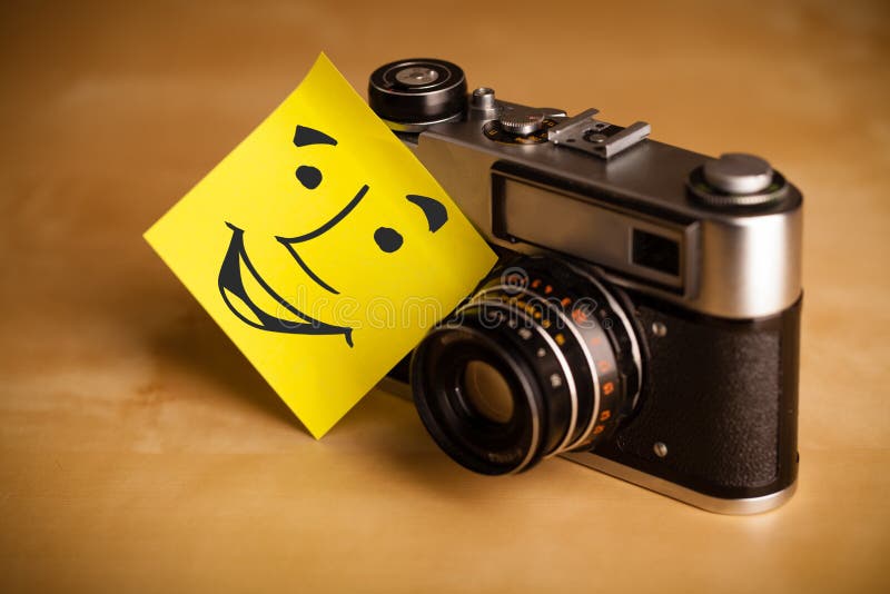 Post-it Note with Smiley Face Sticked on a Photo Camera Stock Image ...