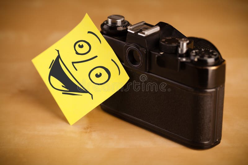 Post-it Note with Smiley Face Sticked on Photo Camera Stock Photo ...