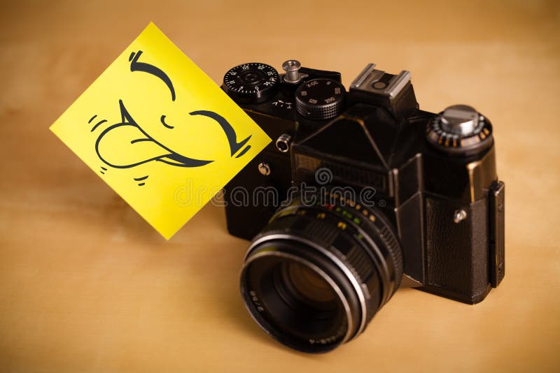 Post-it Note with Smiley Face Sticked on Photo Camera Stock Photo ...