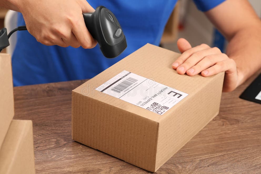 Post Office Worker with Scanner Reading Parcel Barcode at Counter ...