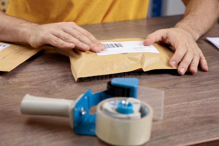 Post Office Worker Sticking Barcode on Parcel at Counter Indoors ...