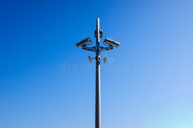 A Post with Several Security Cameras and Light Bulbs To Control ...