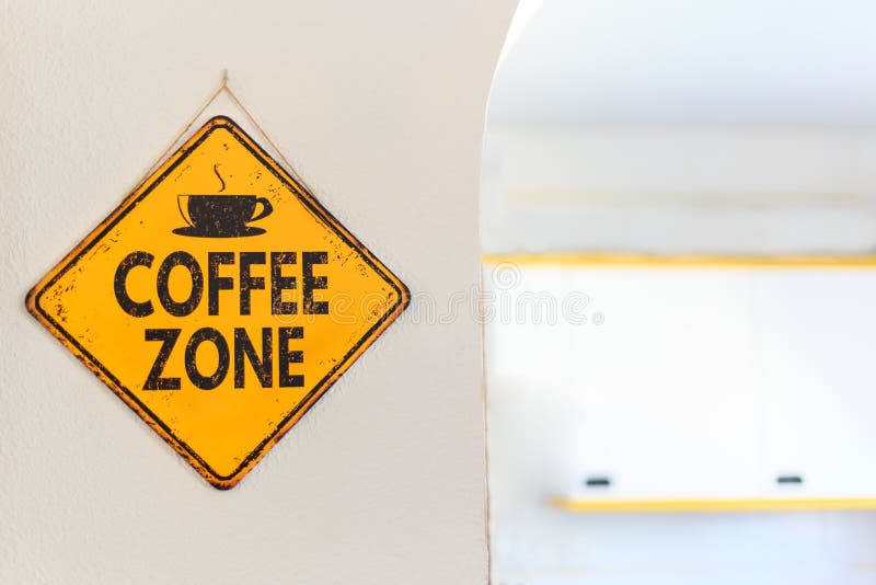 Poster Hanging Yellow on a Wall that Reads: Coffee Zone Stock Photo ...