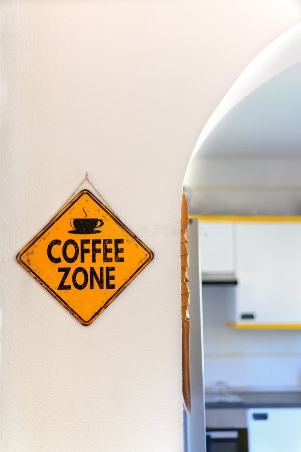 Poster Hanging Yellow on a Wall that Reads: Coffee Zone Stock Image ...