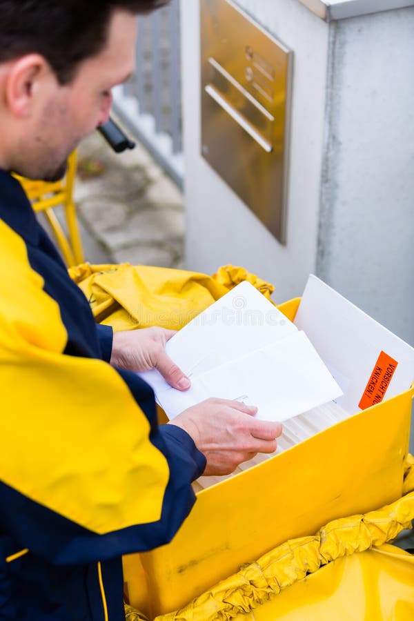 Postman Delivering Letters To Mailbox of Recipient Stock Photo - Image ...
