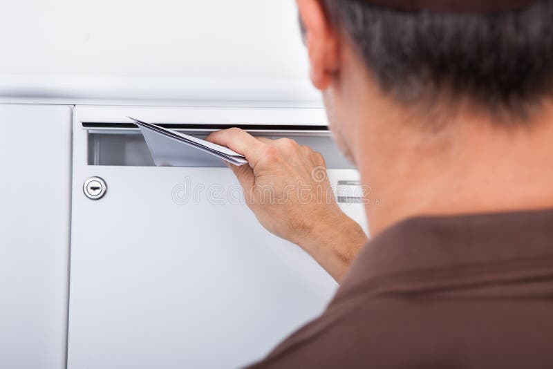 Postman Putting Letters in Mailbox Stock Photo - Image of postal ...