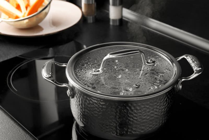 Sieve with Cut Parsnips and Carrots Over Pot of Boiling Water in ...
