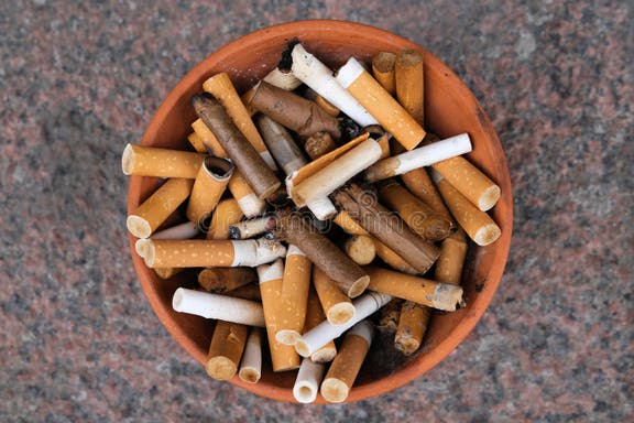 A pot with cigarette buds stock photo. Image of cigarettes - 344564550