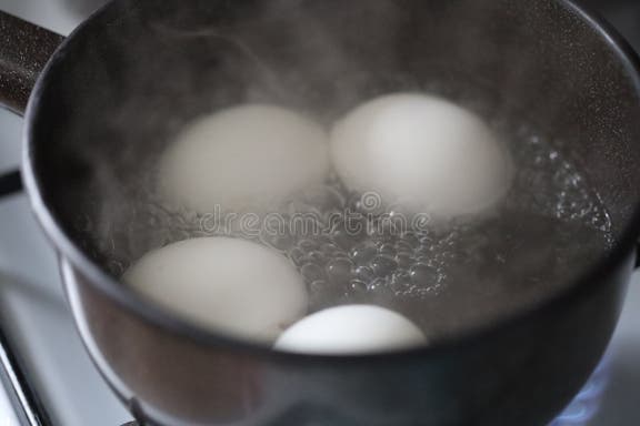A Pot of Eggs Being Cooked on a Stove Stock Photo - Image of culinary ...