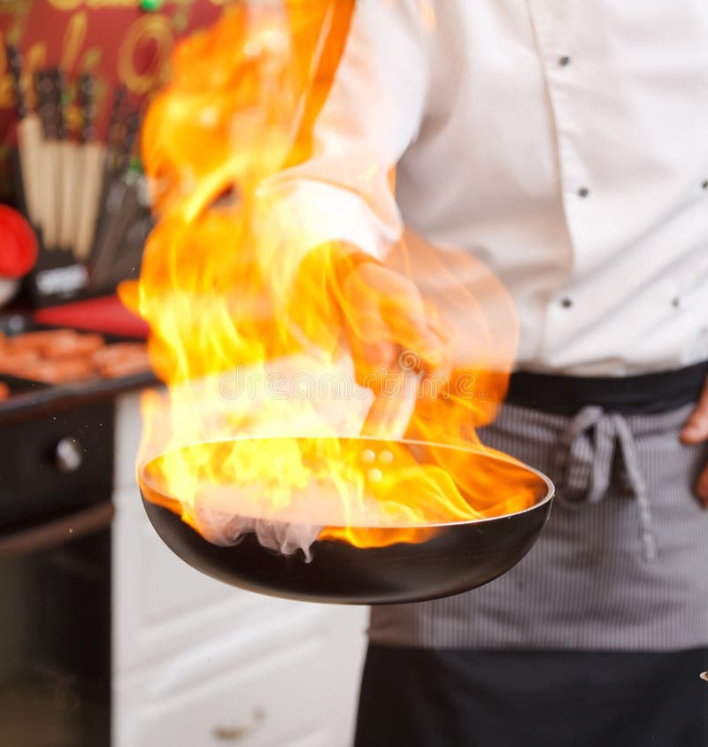 Chef in Restaurant Kitchen at Stove with Pan Stock Image - Image of ...
