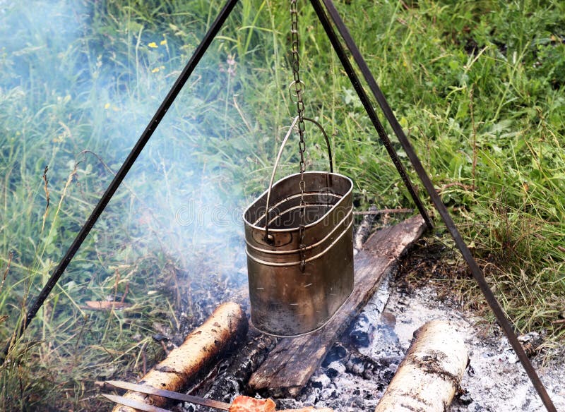 Pot hanging over the fire stock photo. Image of wood - 65947706