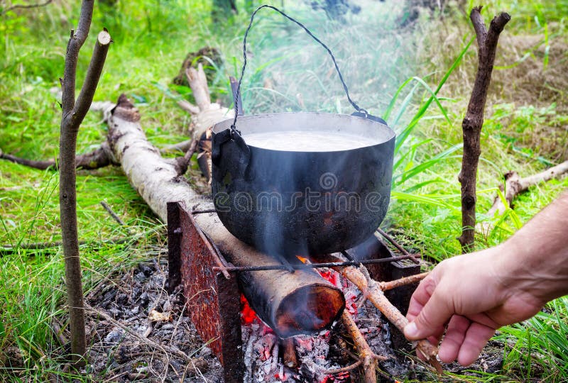 Pot on the Fire with Firewood Tosses Hand Stock Photo - Image of ...