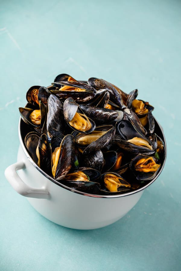 Pot Full of Steamed Mussels on Blue Background Stock Photo - Image of ...