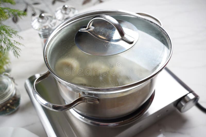 Pot with Lid Full of Dumplings in Boiling Water. Stock Photo - Image of ...