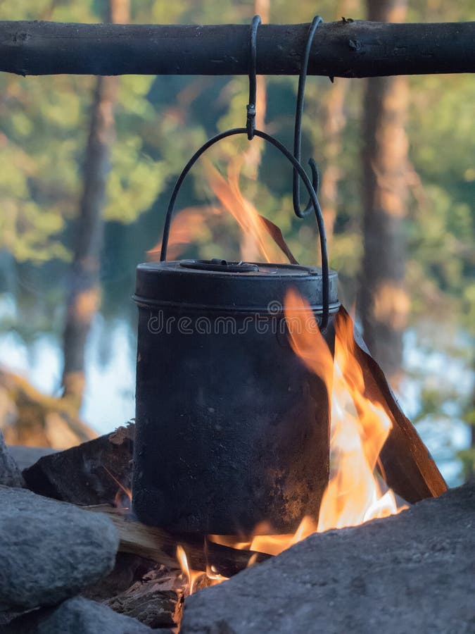 Pot hanging over the fire stock photo. Image of wood - 65947706