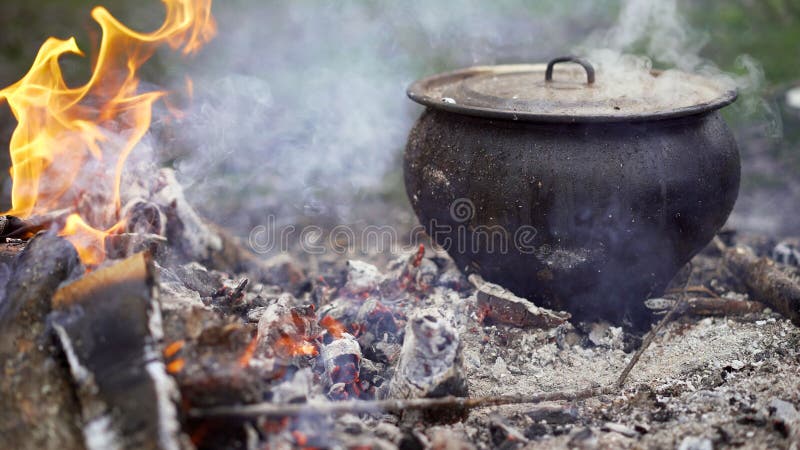 A Pot of Soup Cooked Over a Fire. Cooking Traditional Soup Over an Open ...