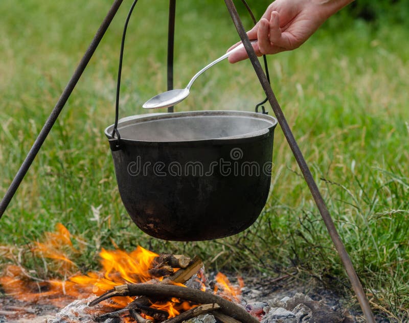 A Pot in Which Soup is Cooked on a Tripod Stands on a Fire Stock Photo ...