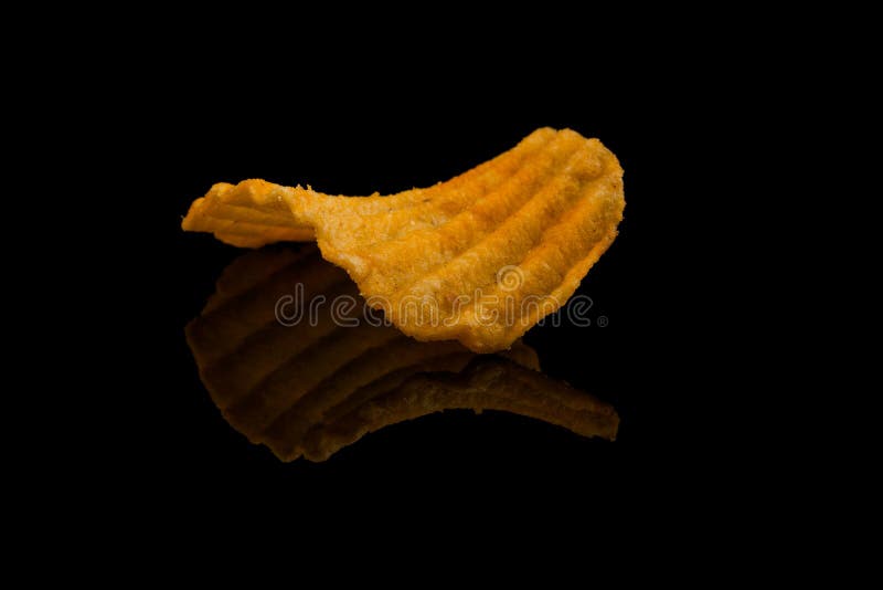 Potato Chip on Black Surface Stock Photo - Image of fatty, isolated ...