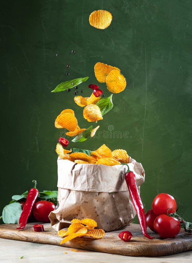 Potato Chips Fall into a Paper Bag. Spicy Chips in a Craft Bag. Flying ...