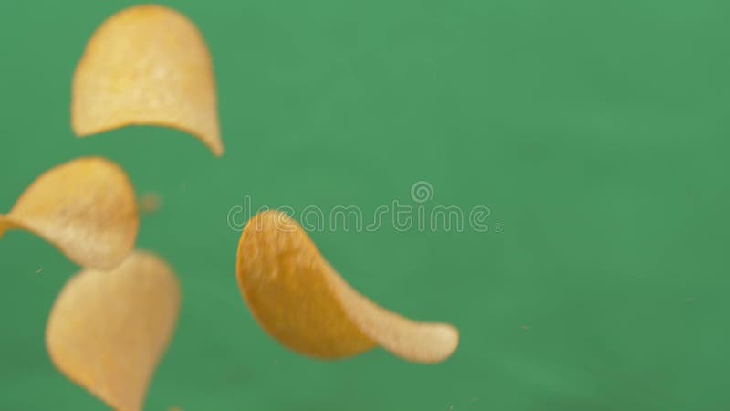 Potato Chips in Free Fall on a Green Background. Slow Motion. Pringles ...