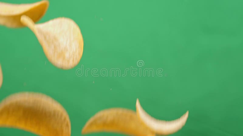 Potato Chips in Free Fall on a Green Background. Slow Motion. Pringles ...