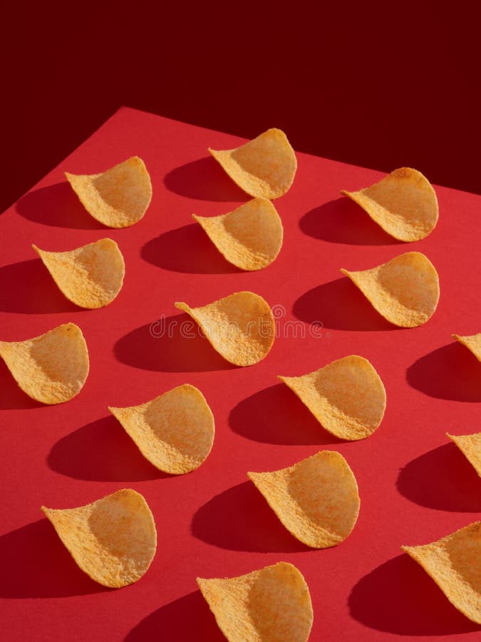 Potato Chips on Red Background with Very Sharp Shadows Stock Photo ...