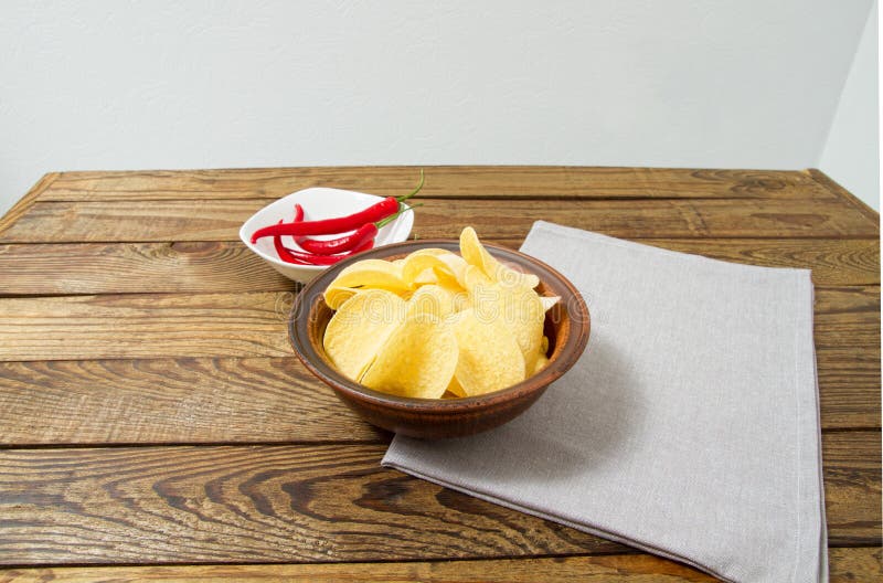 Potato Chips and Red Chili Peper on Wooden Table,grey Tablecloth Stock ...