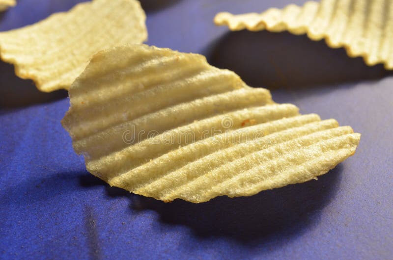 Potato Chips with Ridged or Waves on Blue Surface Stock Photo - Image ...