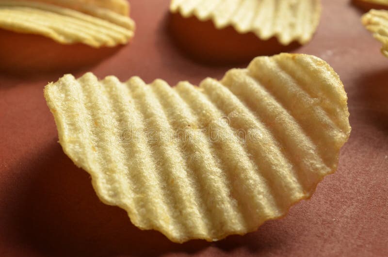 Potato Chips with Ridged or Waves on Brown Surface Stock Image - Image ...