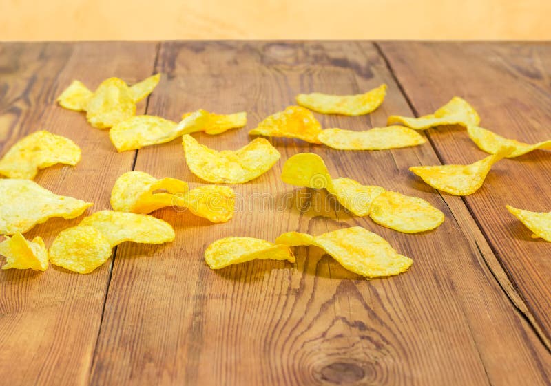Potato Chips Scattered on the Old Wooden Surface Closeup Stock Image ...